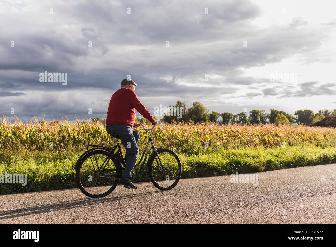 Old person riding bicycle hi-res stock photography and images - Alamy