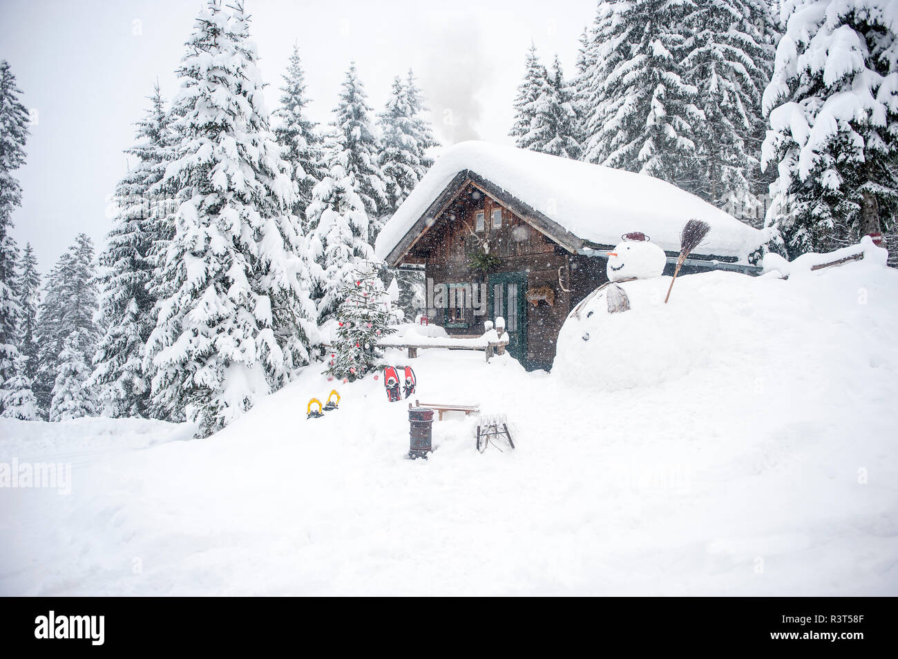 Austria, Altenmarkt-Zauchensee, snowman, sledges and Christmas tree at ...