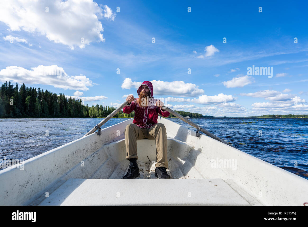 Finland, Man rowing in a boat on a lake Stock Photo - Alamy