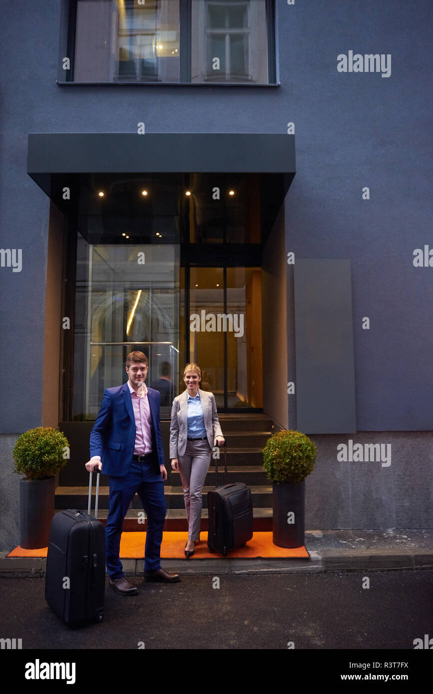business people couple entering hotel Stock Photo - Alamy