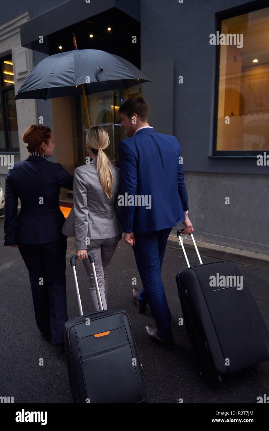 business people couple entering hotel Stock Photo - Alamy