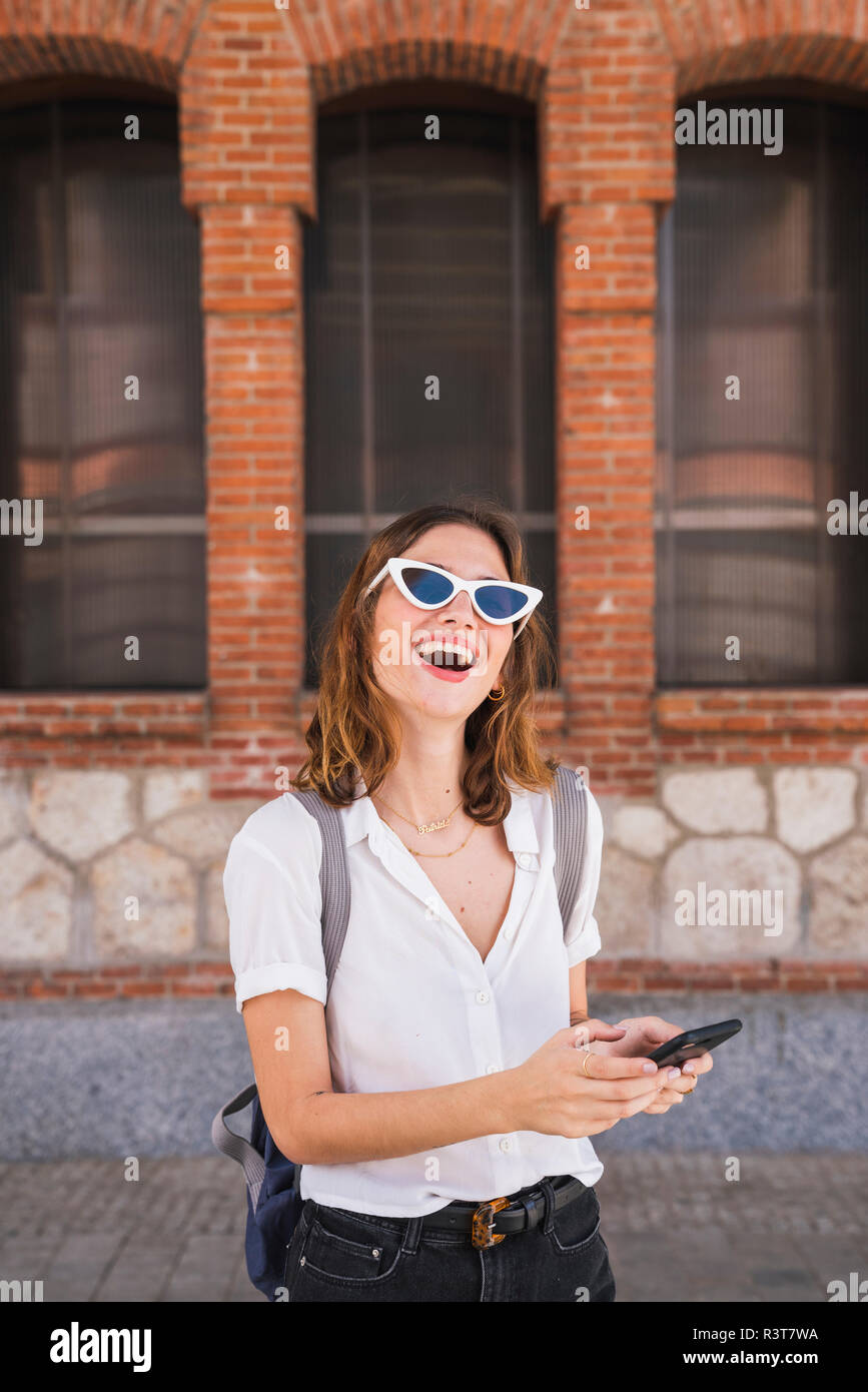 Young woman sight seeing in Madrid, using smartphone Stock Photo - Alamy