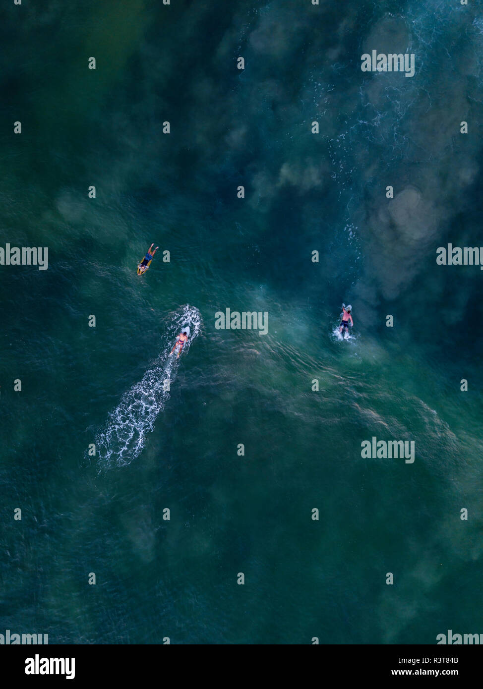 Indonesia, Bali, Aerial view of Dreamland beach, three surfers from ...