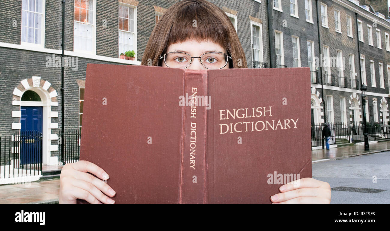 girl looks over English Dictionary and street Stock Photo - Alamy