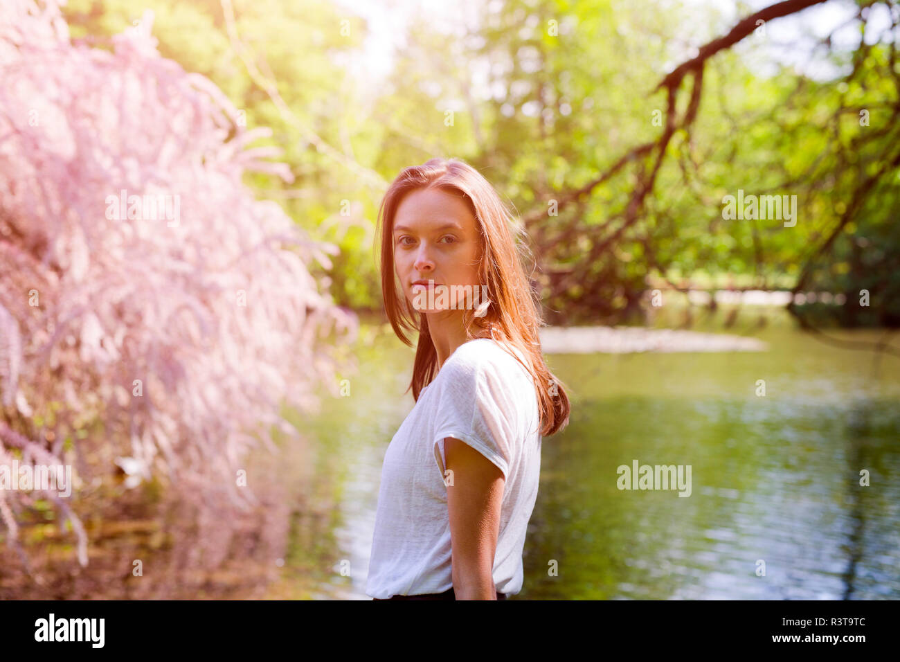 Portrait of attractive young woman at a pond Stock Photo - Alamy