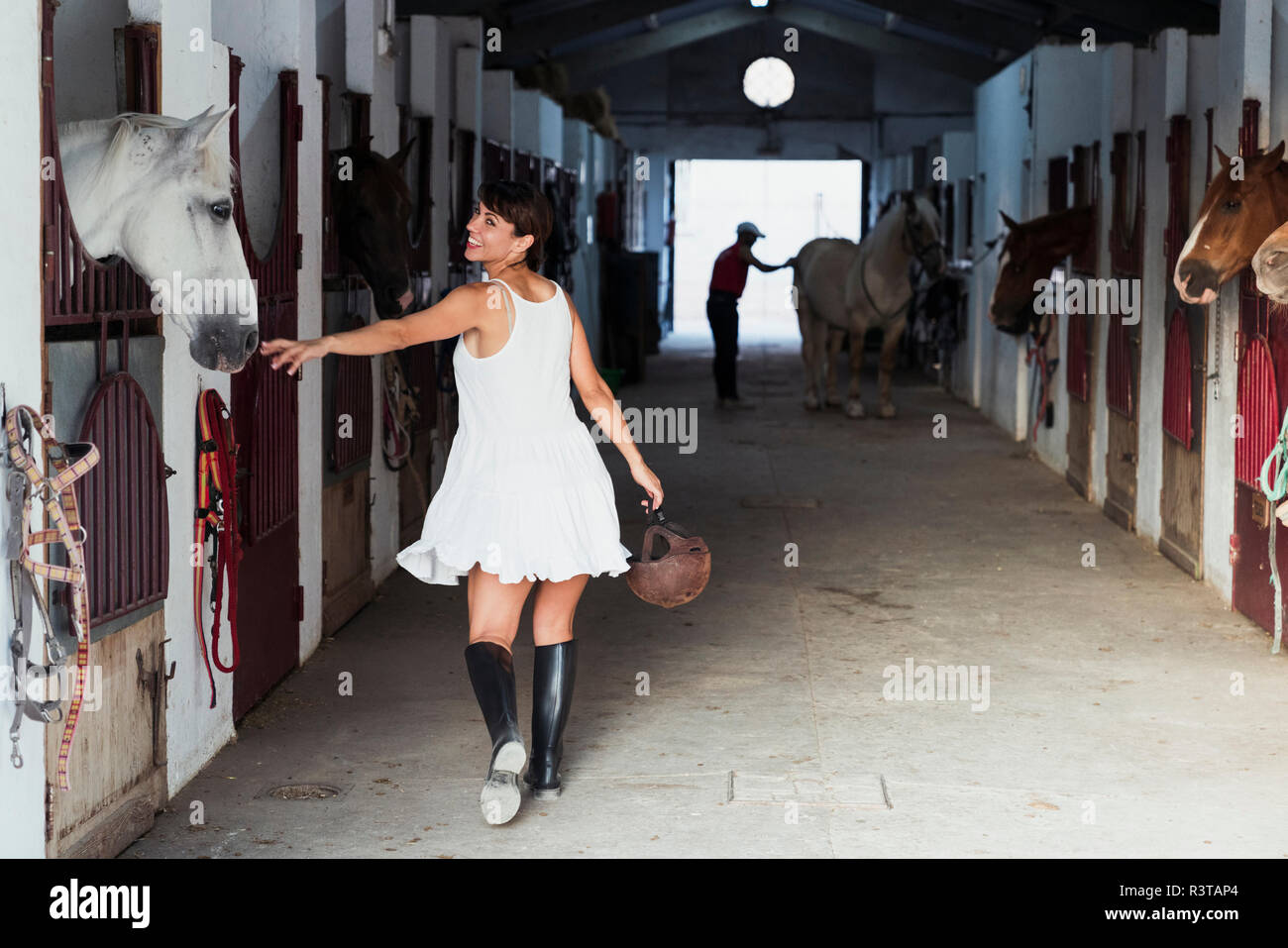 Woman in stables hi-res stock photography and images - Alamy