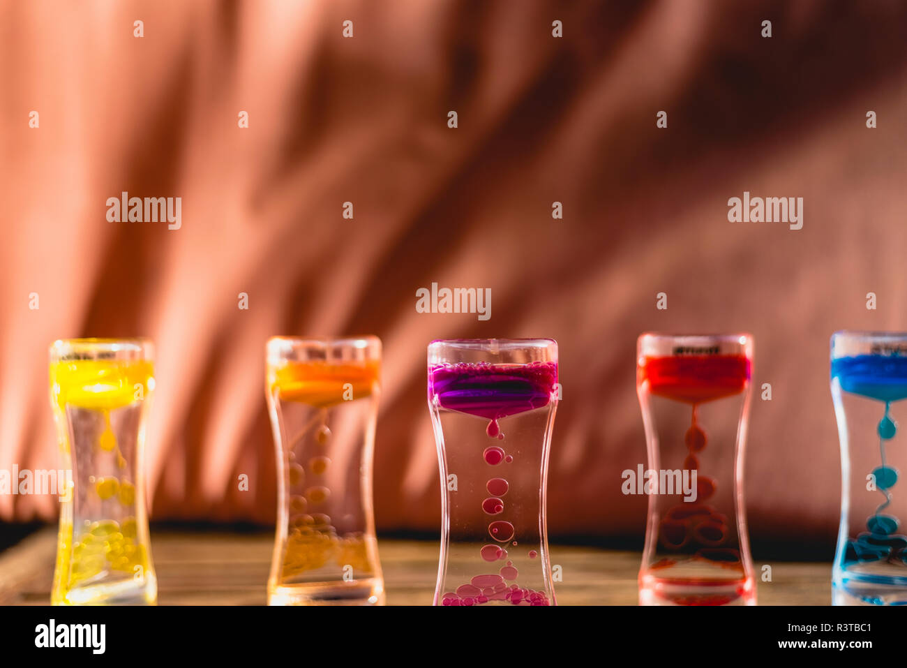 Toy with water and drops of oil colors Stock Photo - Alamy