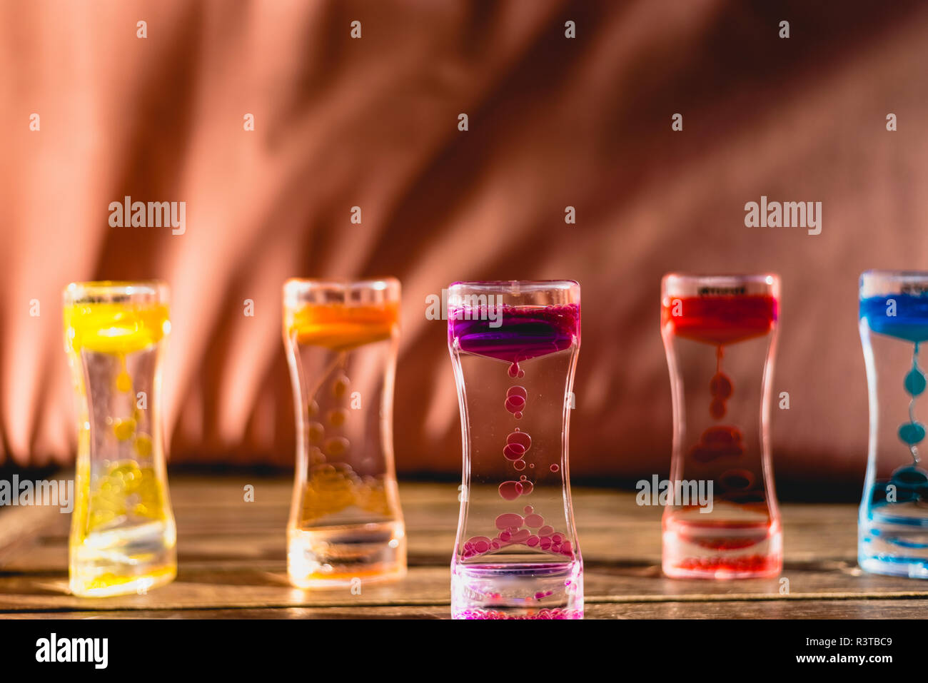 Toy with water and drops of oil colors Stock Photo - Alamy