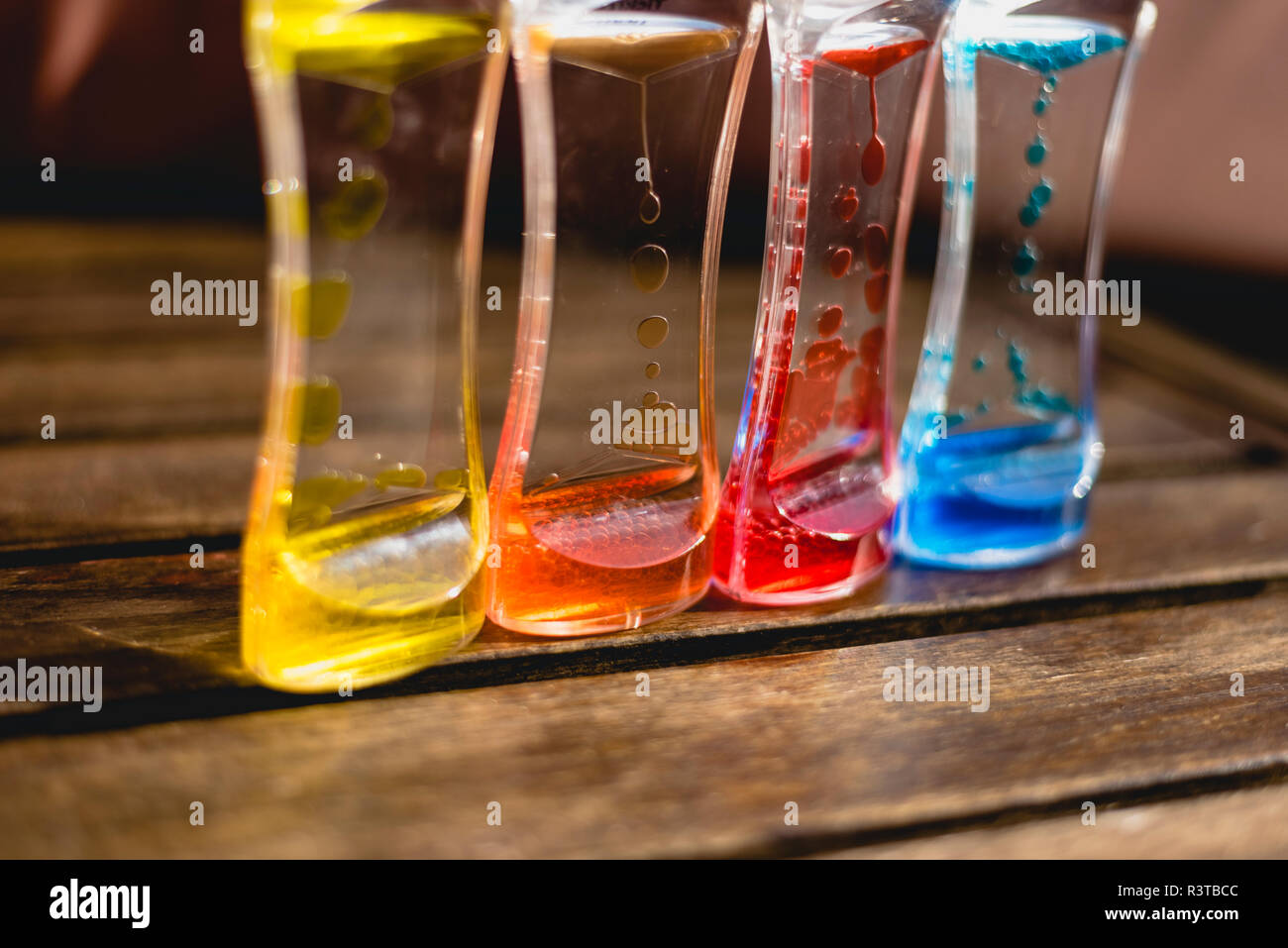 Toy with water and drops of oil colors Stock Photo - Alamy