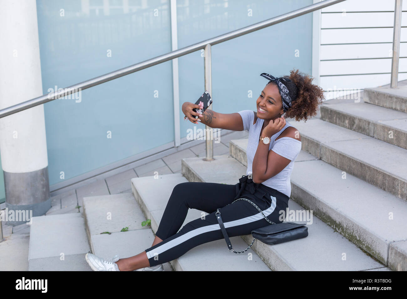 Woman seated on stairs hi-res stock photography and images - Alamy
