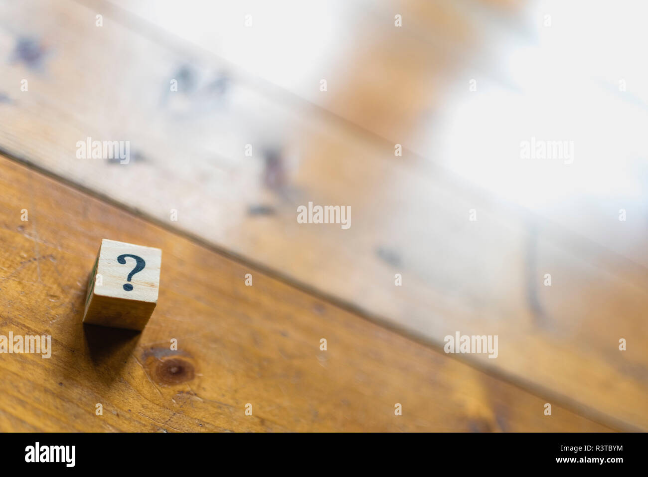 Wooden dice with question mark and doubt Stock Photo - Alamy