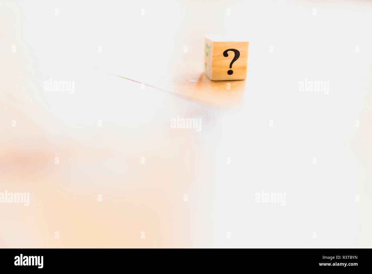 Wooden dice with question mark and doubt Stock Photo - Alamy