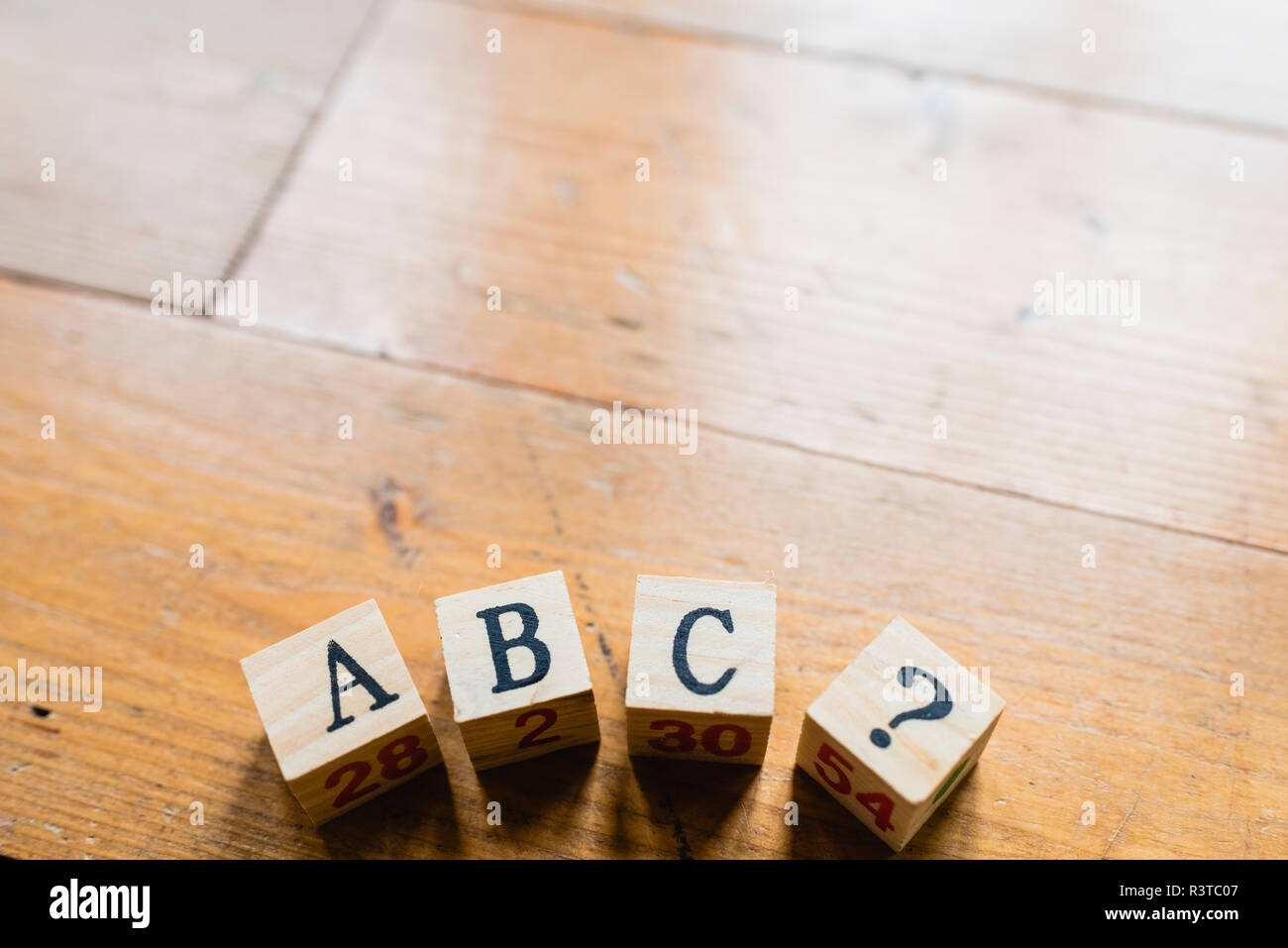 Wood dice with letters abc and interrogation Stock Photo - Alamy