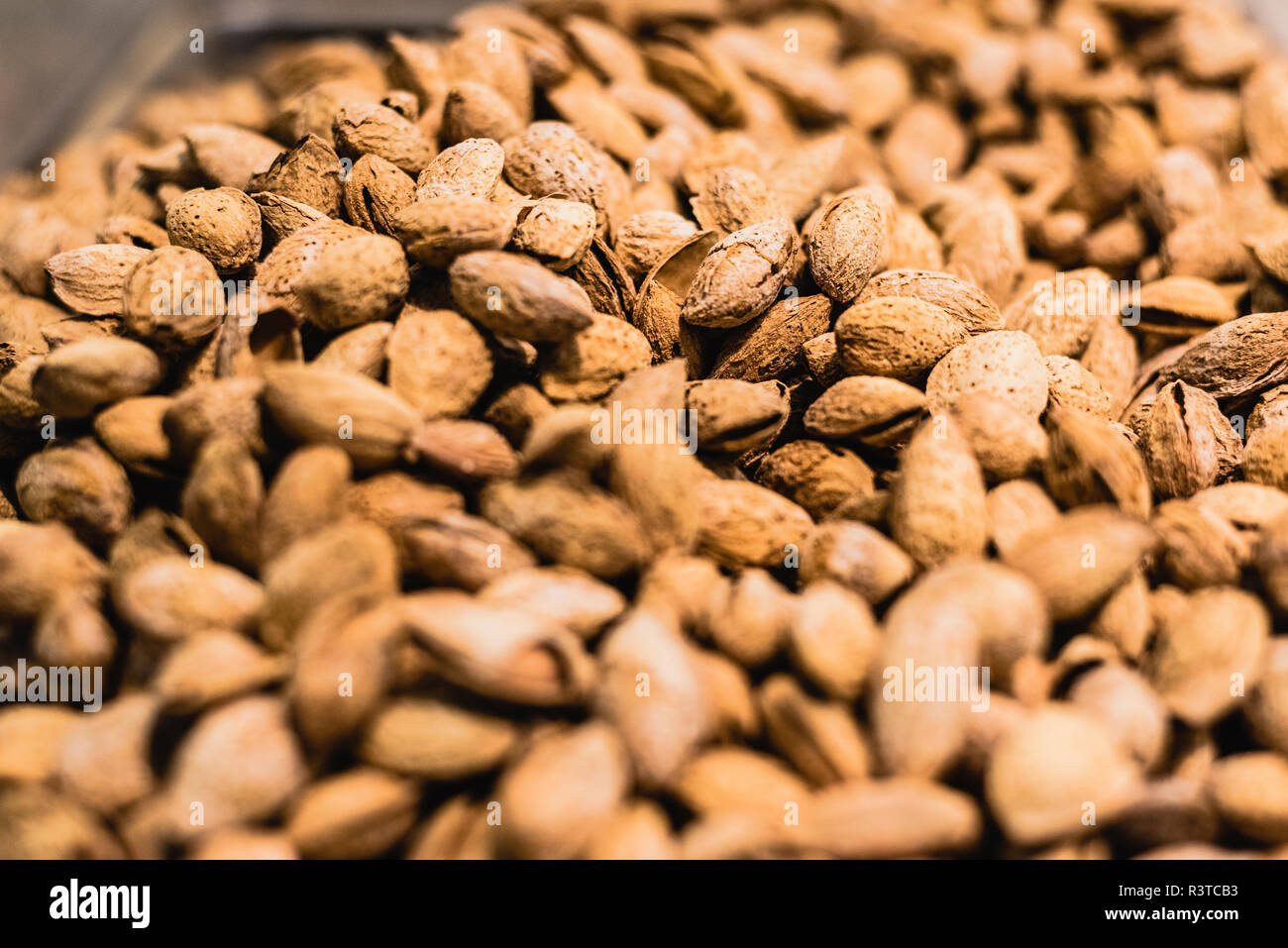 A pile of dried unpeeled almonds Stock Photo - Alamy