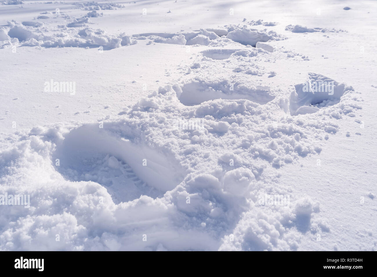 Footprint and hands on snow for texture background Stock Photo - Alamy