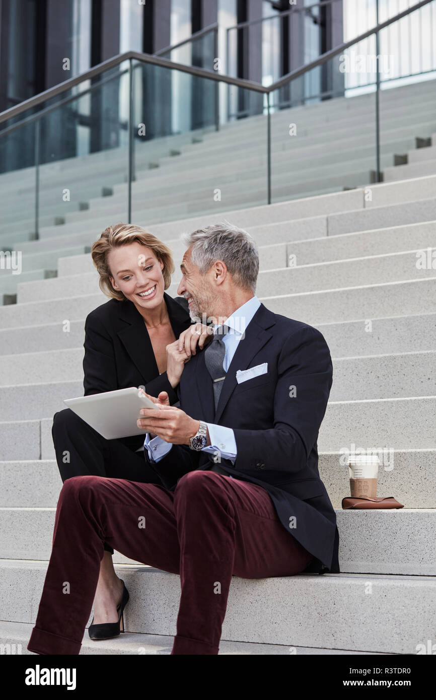 Two people sitting on stairs hi-res stock photography and images - Alamy
