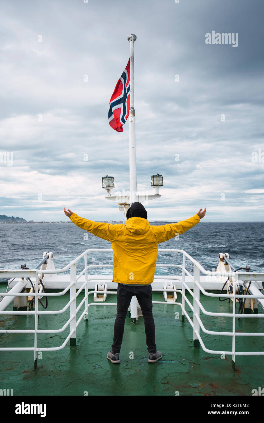 Rear man standing ship deck outstretched arms hi-res stock photography ...