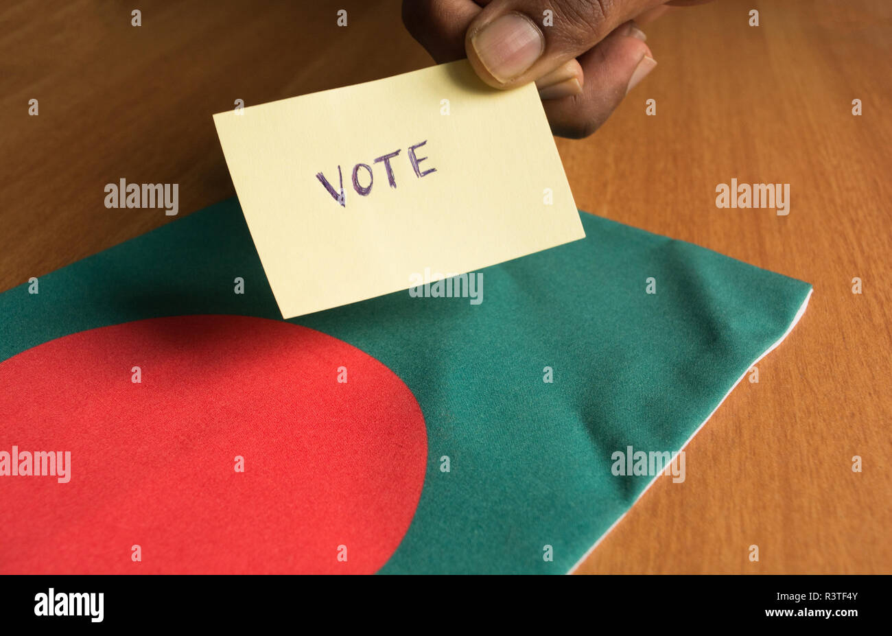Voting concept - Person holding Hand Written Voting Sticker on ...