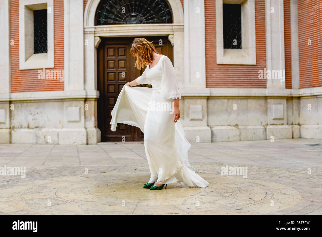 Newlywed bride dancing with her wedding dress Stock Photo - Alamy