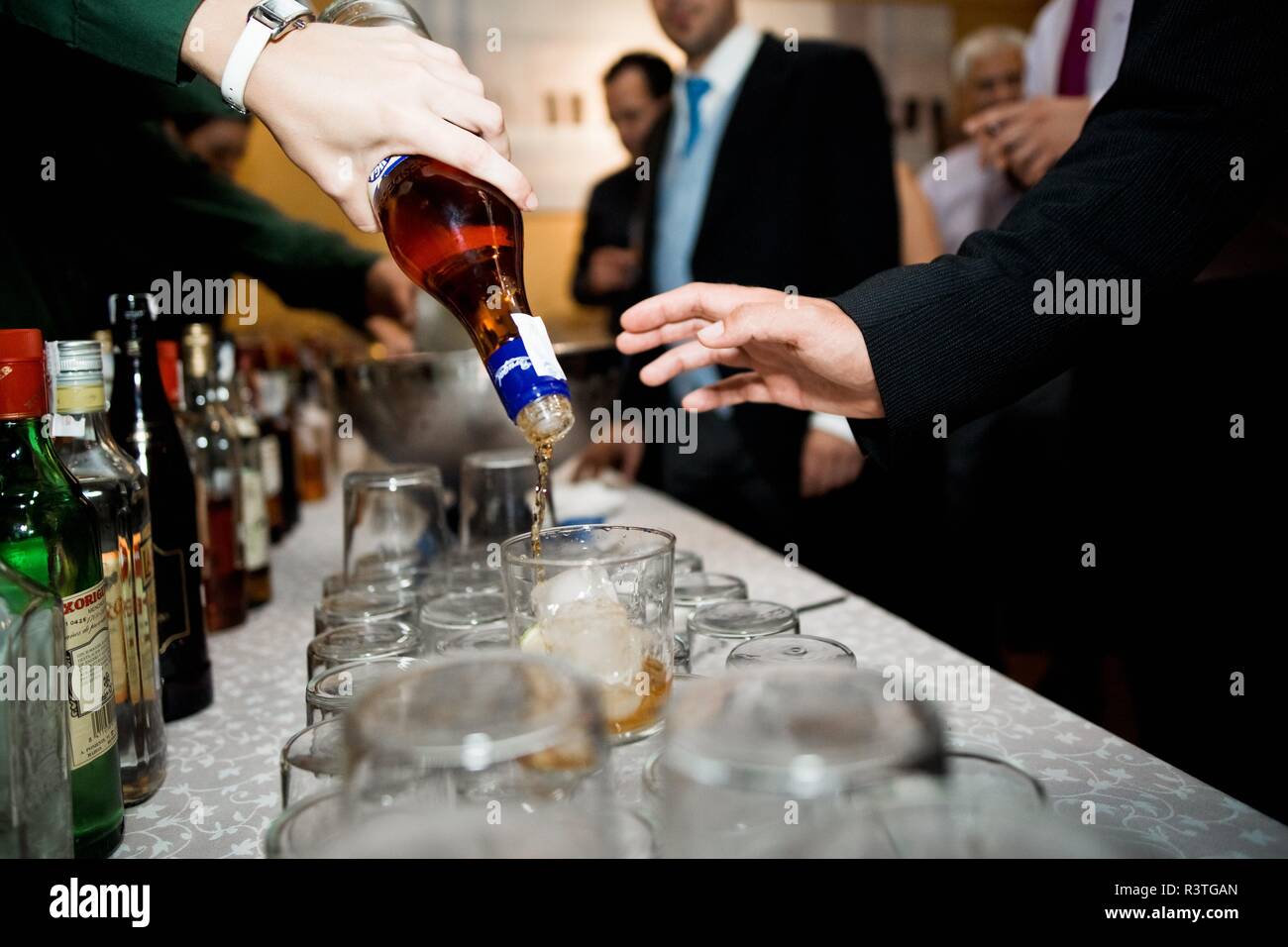 Waiters serving drinks during the cocktail Stock Photo - Alamy
