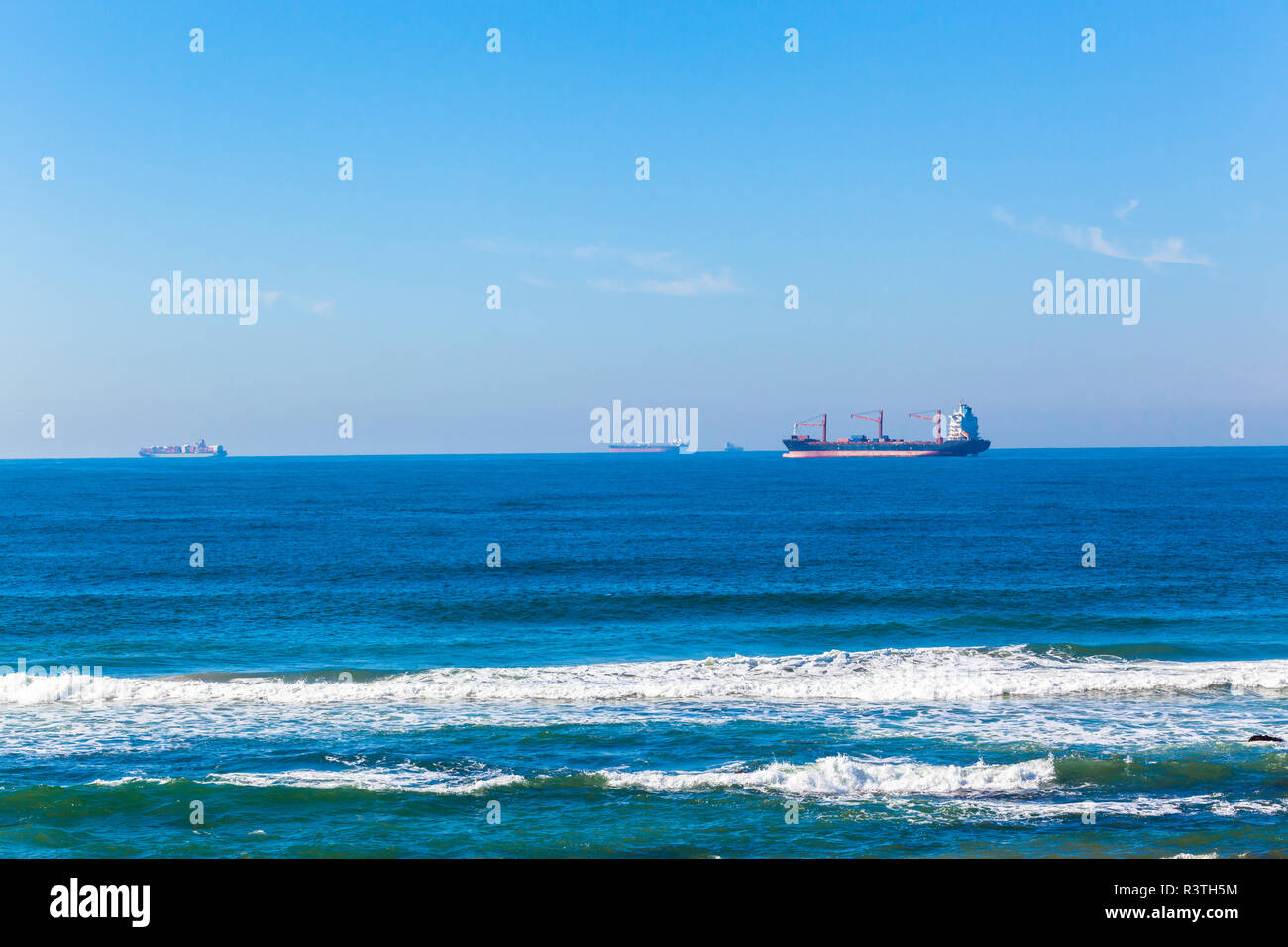 Ships on blue ocean horizon seas anchored waiting port harbor entry ...