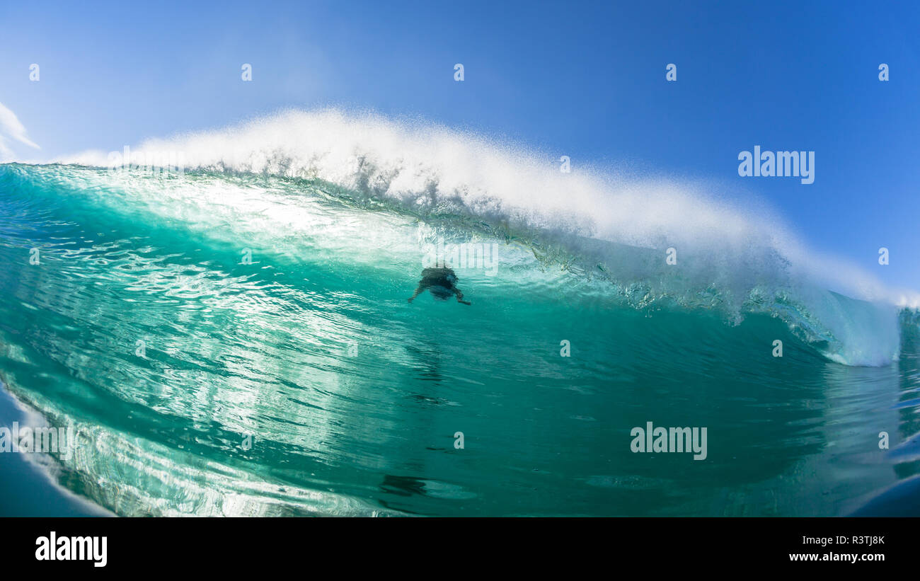 Surfer surfing action motion to escape ocean wave with push underwater ...