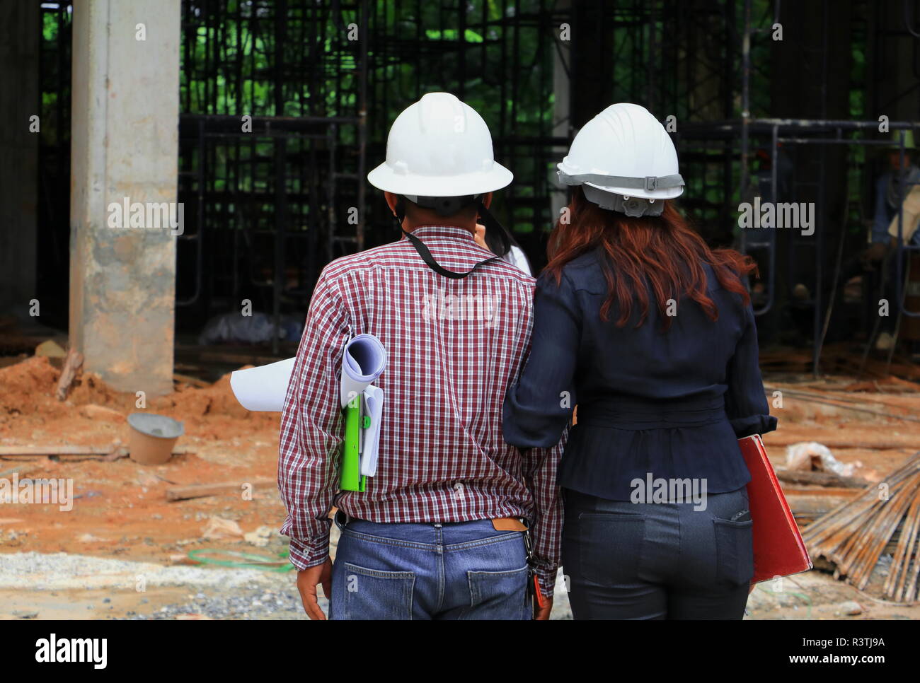 architect-engineer businessman and woman wear helmet in construction ...