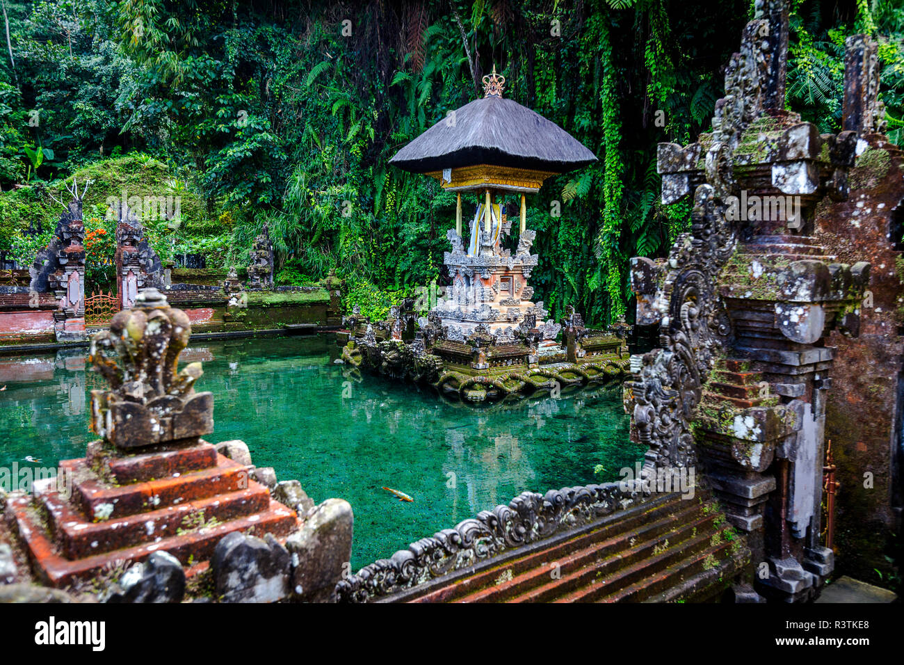 Sebatu Hindu Temple, Bali. Aqua pool with stone wall and worshipping ...