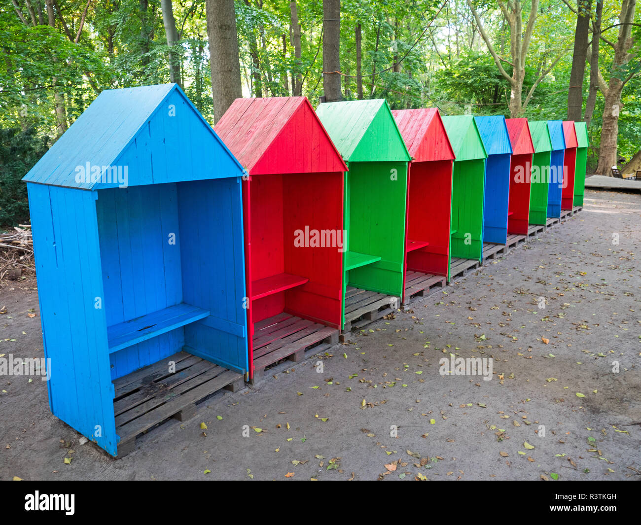 colorful wooden huts in the forest Stock Photo - Alamy
