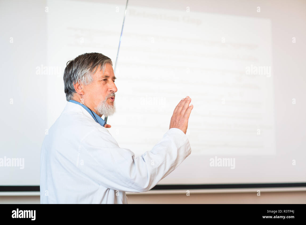 Senior chemistry professor giving a lecture in front of classroom Stock ...