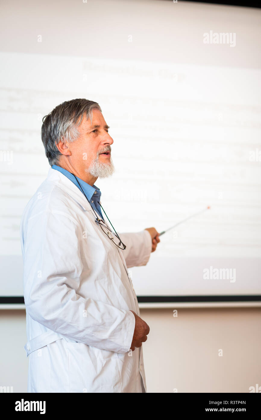 Senior chemistry professor giving a lecture in front of classroom Stock ...
