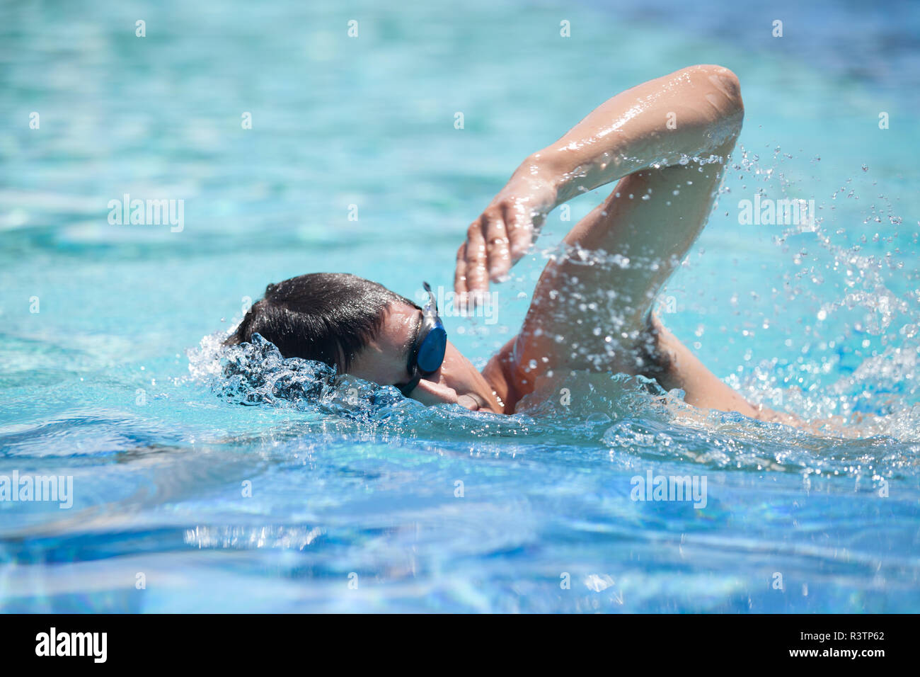 Young man swimming the front crawl in a pool Stock Photo - Alamy