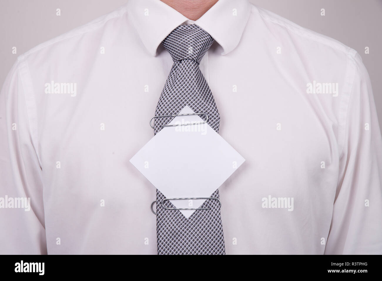 Office worker with note on tie Stock Photo - Alamy
