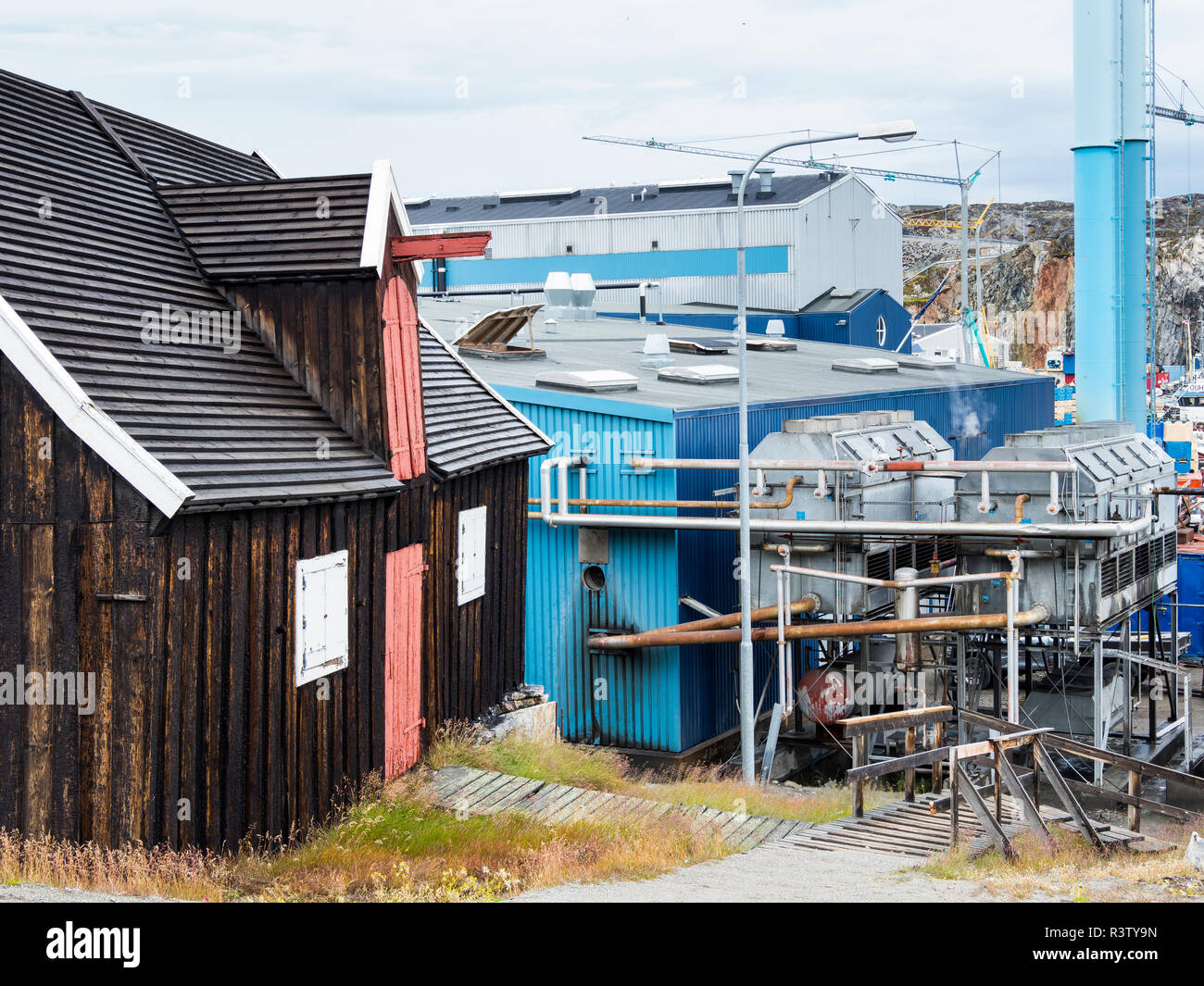 Old magazine building in front of fish factory. The icefjord nearby is ...
