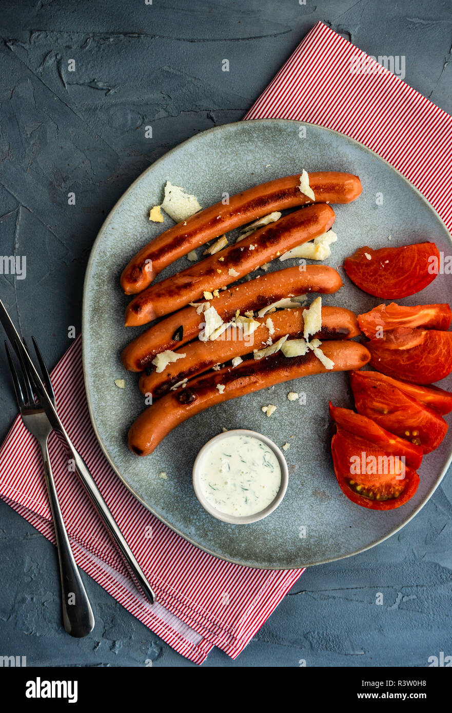 Traditional german food - sausages, cheese and tomatoes with sour cream ...