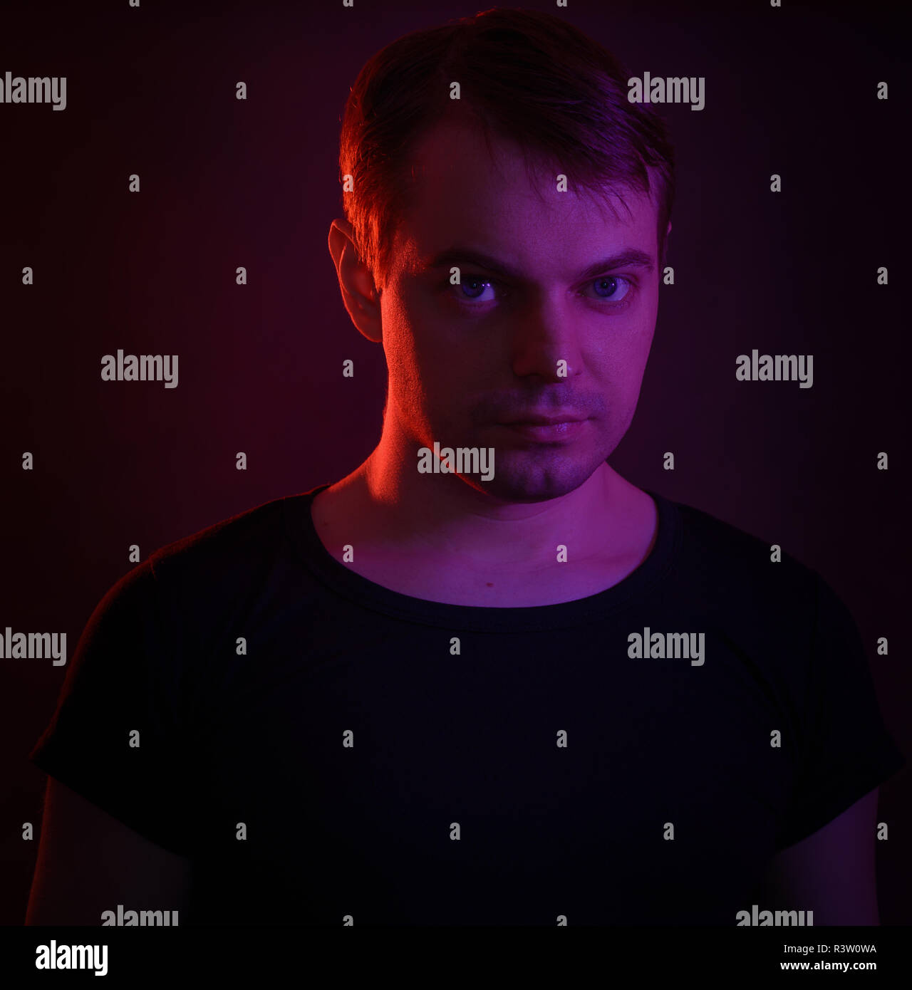 Portrait of a man with colored light and dark background Stock Photo ...