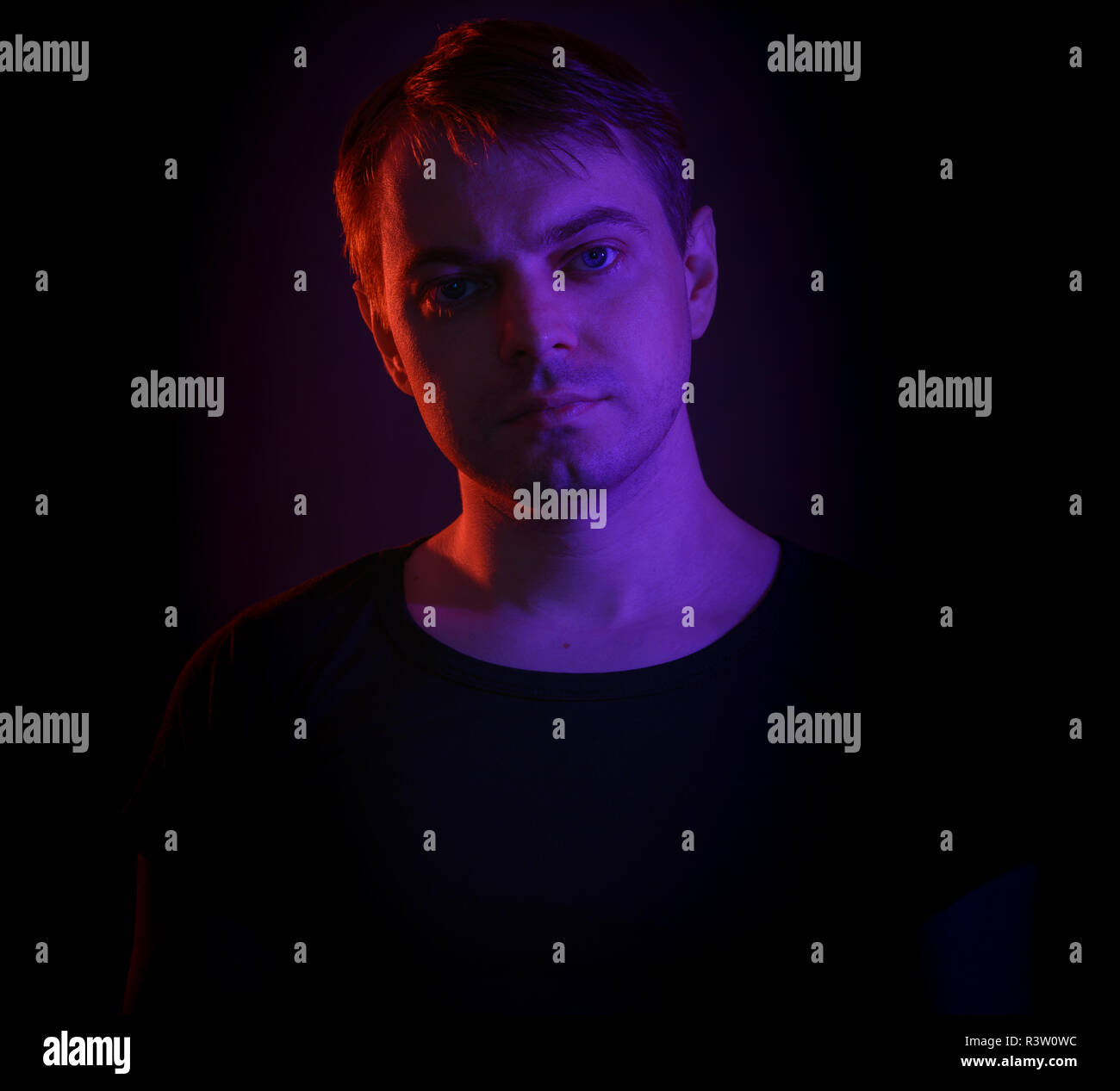 Portrait of a man with colored light and dark background Stock Photo ...