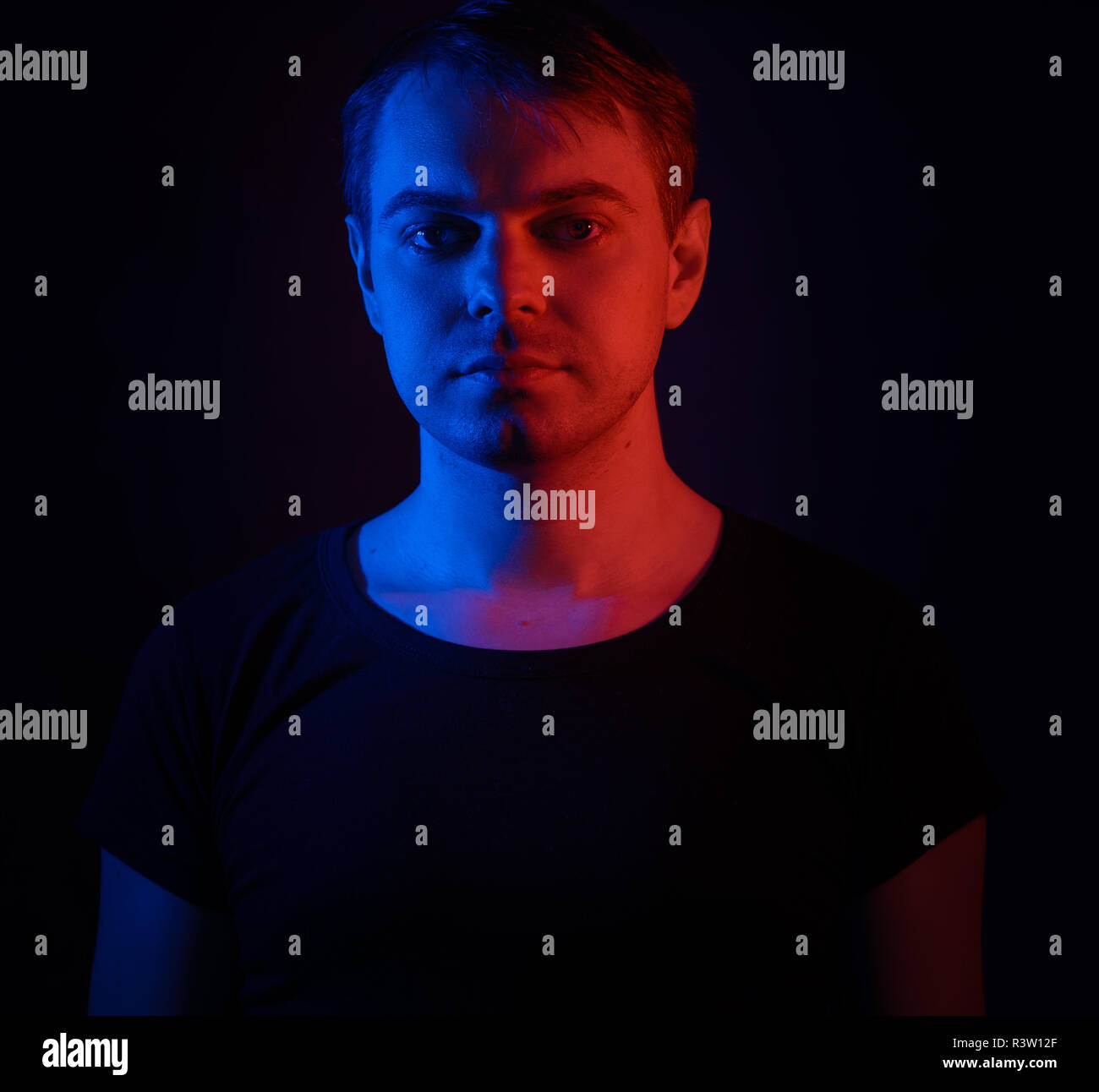 Portrait of a man with colored light and dark background Stock Photo ...