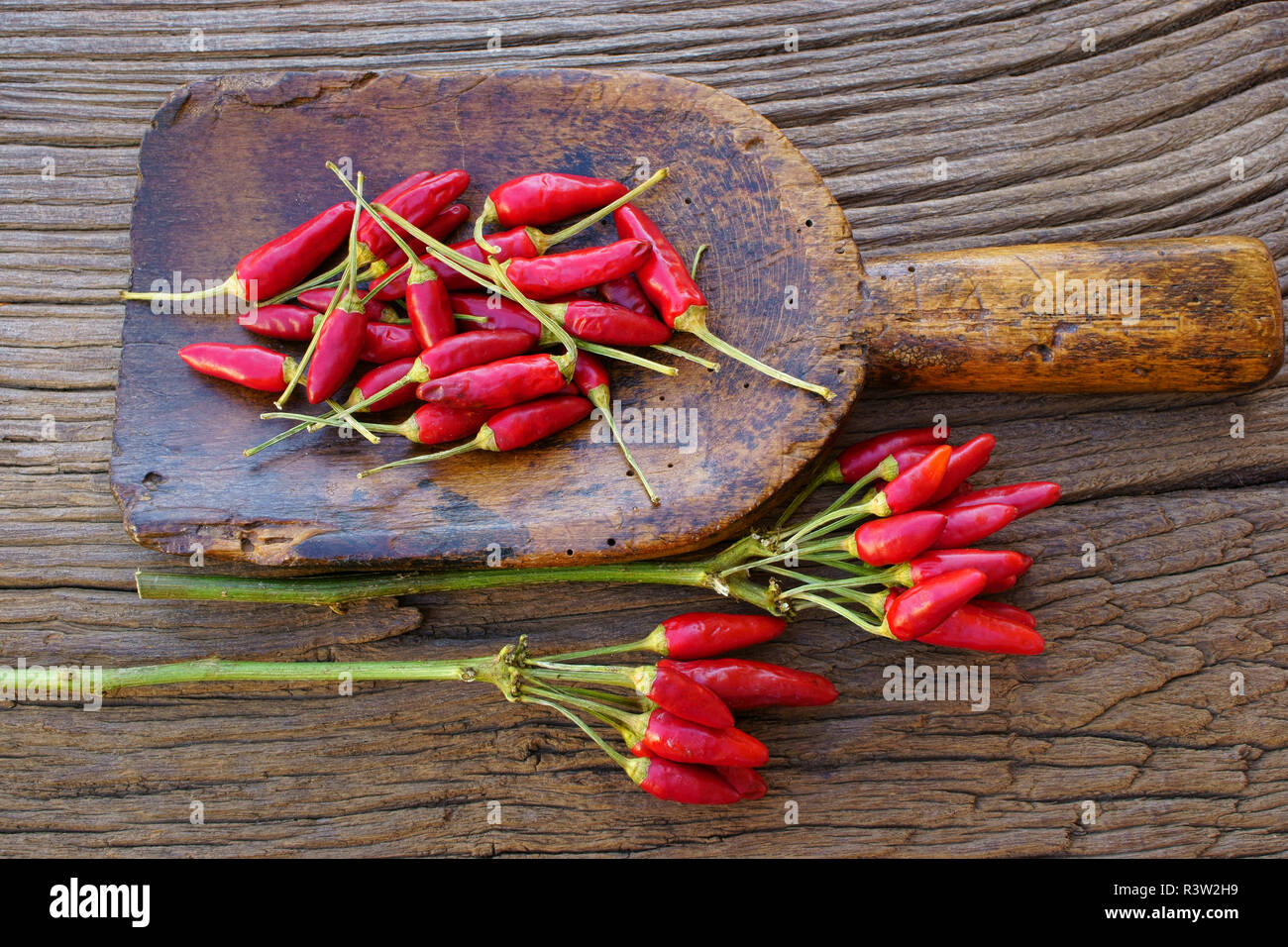 chili peppers on large antique spice scoop Stock Photo - Alamy