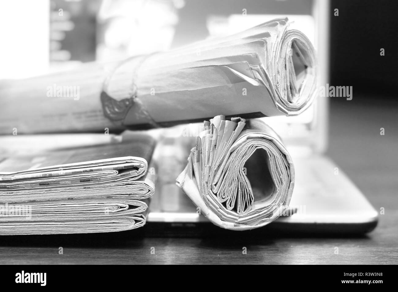 Newspapers and computer. Folded and rolled papers and magazines on ...