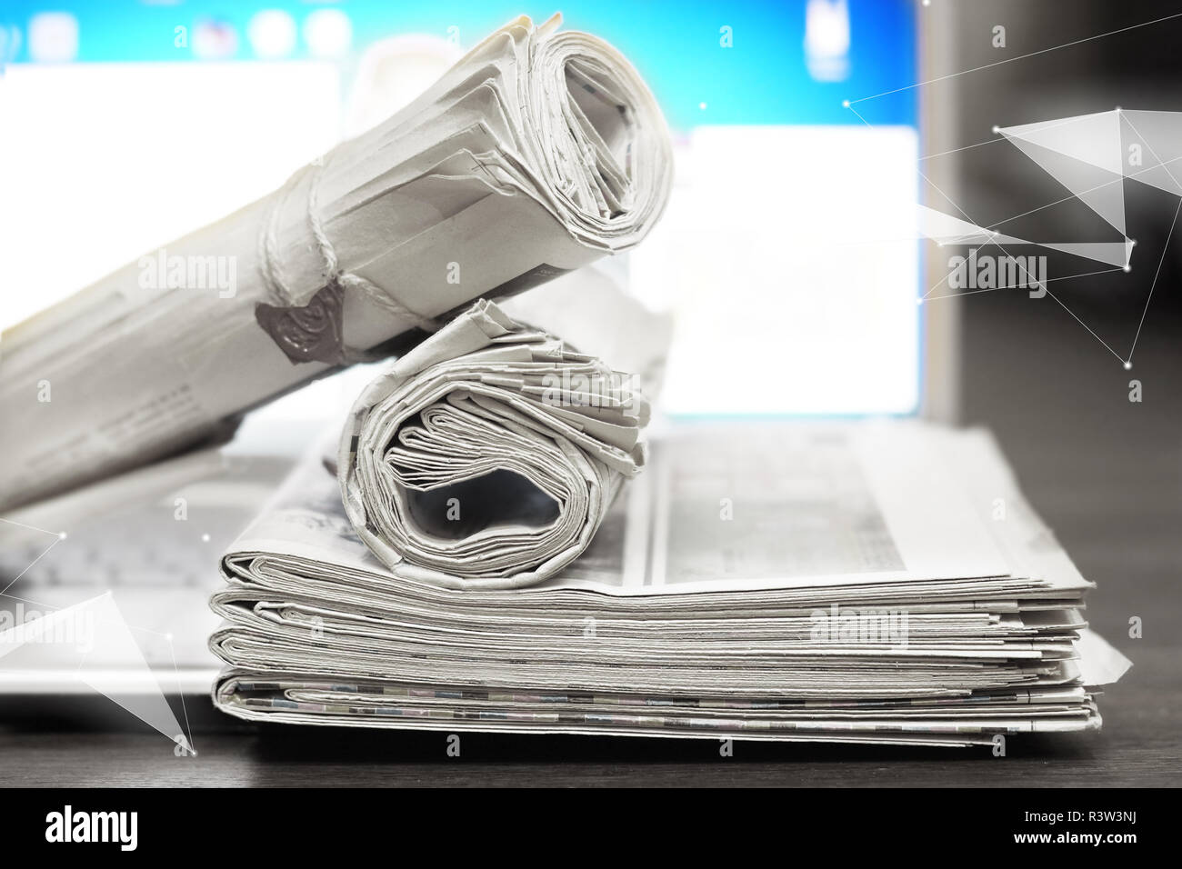 Laptop and newspapers with virtual abstract poligon projection. Digital ...