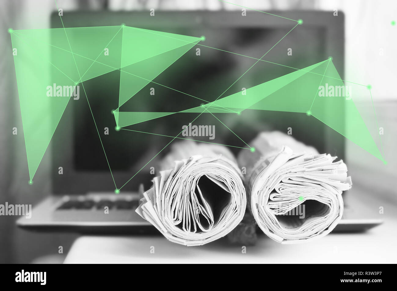 Laptop and newspapers with virtual abstract poligon projection. Digital ...