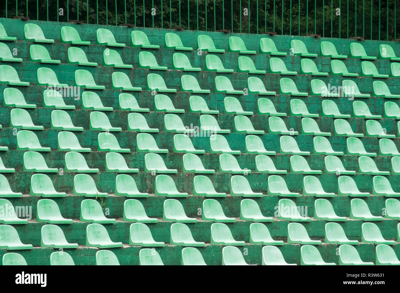 Empty green plastic spectators seats closeup on tennis court stand ...