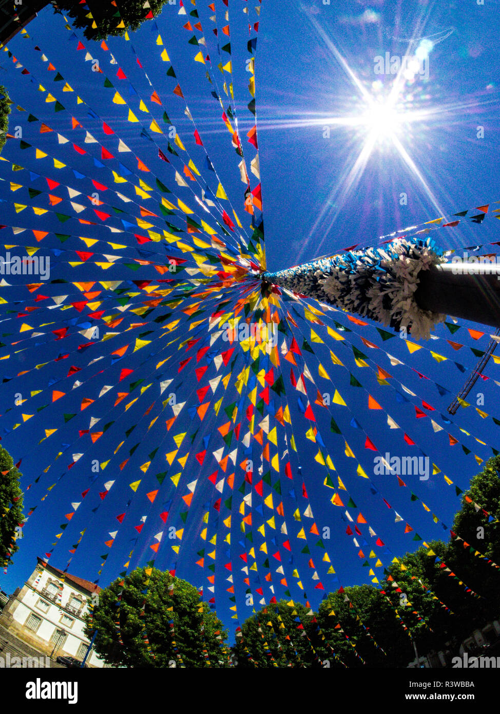 Multicolored streamer decorations hanging from pole Stock Photo - Alamy