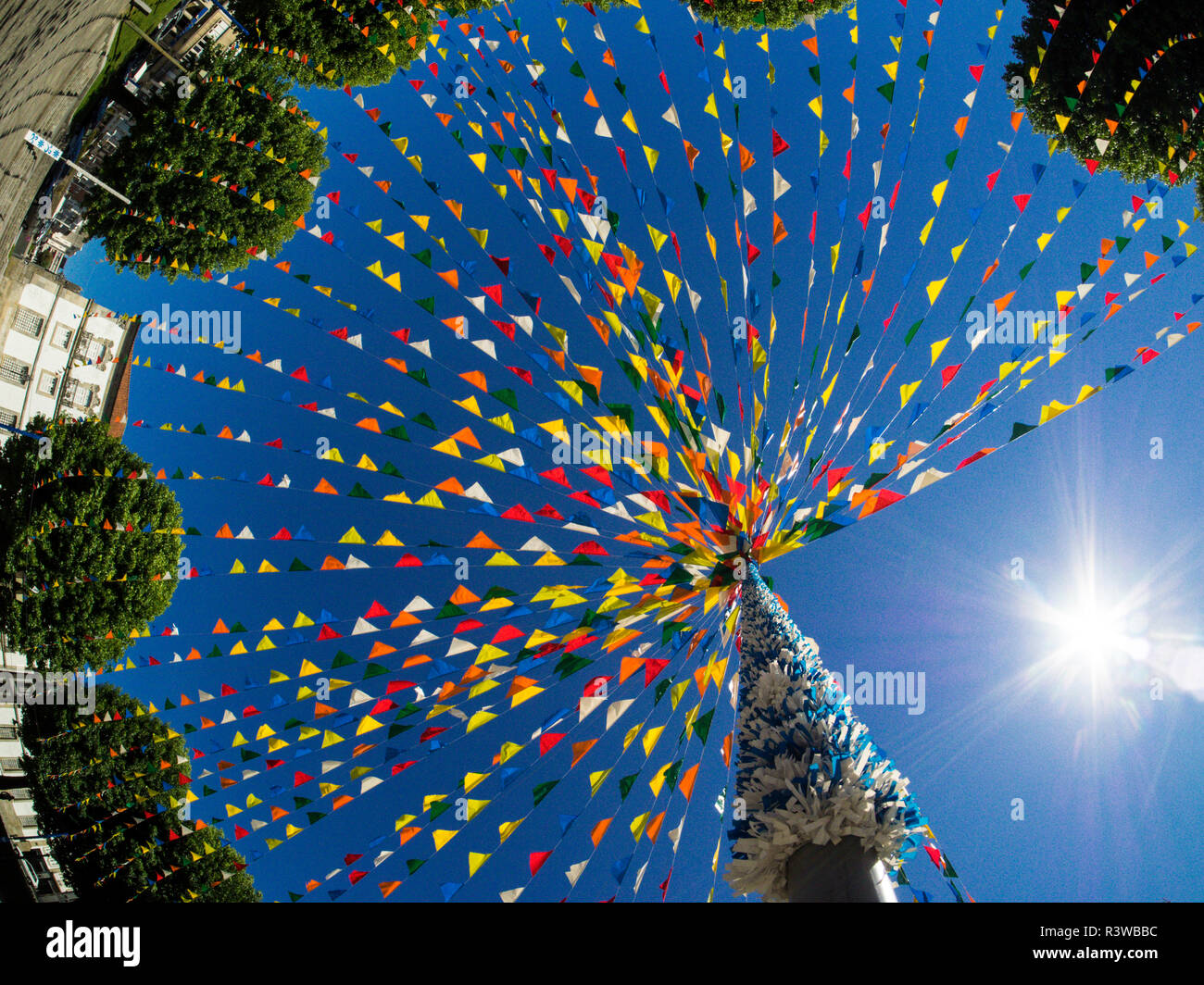 Multicolored streamer decorations hanging from pole Stock Photo - Alamy