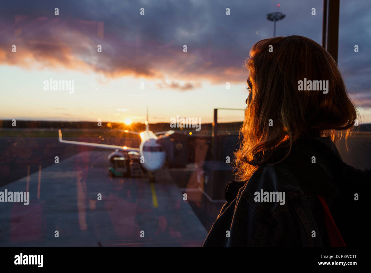 Woman looking through plane window hi-res stock photography and images ...