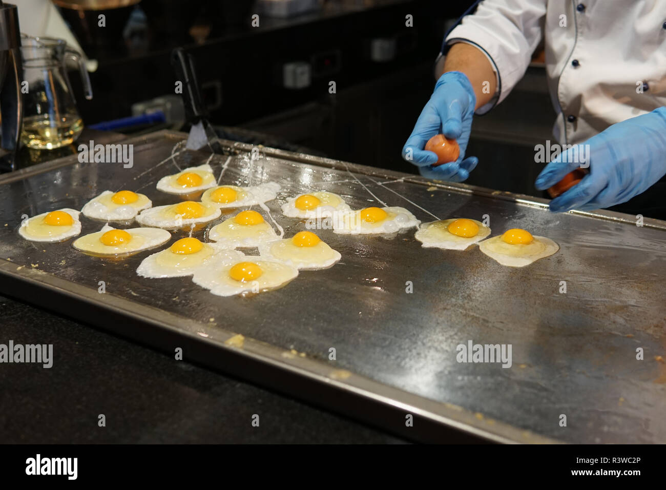 the Cook prepares the eggs in the kitchen Stock Photo - Alamy