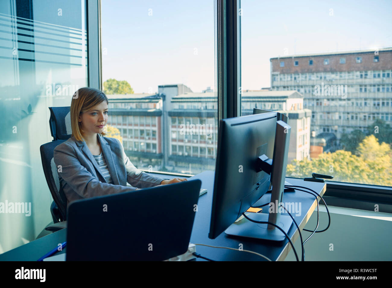 Businesswoman using computer in office Stock Photo - Alamy