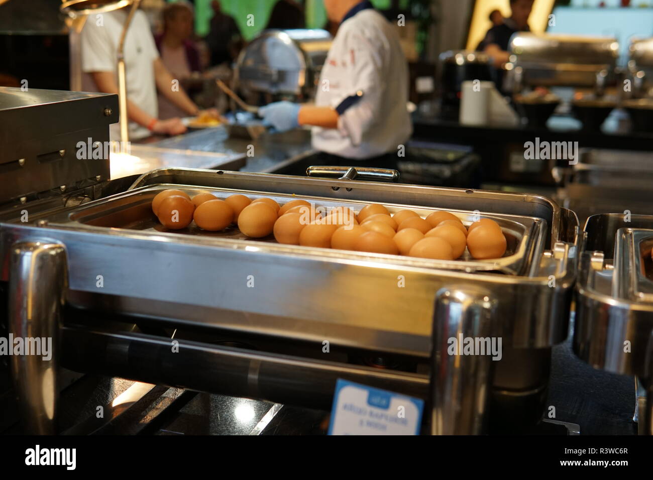 the Cook prepares the eggs in the kitchen Stock Photo - Alamy