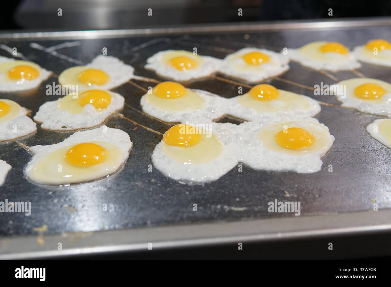 the Cook prepares the eggs in the kitchen Stock Photo - Alamy